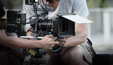Premium Photo Film Industry Filming With Professional Camera Videographer Holding 4k Cam On