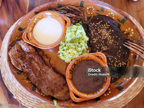 Authentic Mexican Tampiquena Steak Served With Mole Beans And Guacamole