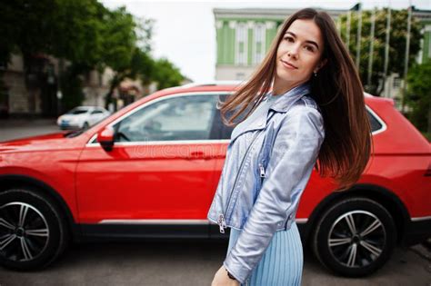 Outdoor Photo Of Gorgeous Woman Posing Near Orange Suv Car Stock Image