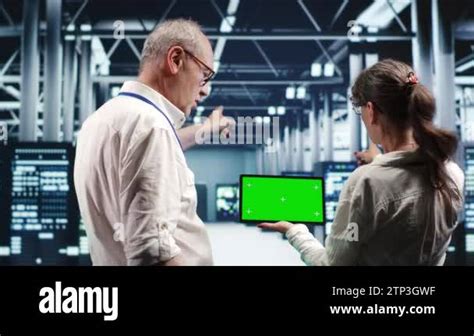 Specialists Using Mockup Tablet To Monitor Energy Efficient Data Center Clusters Server Units