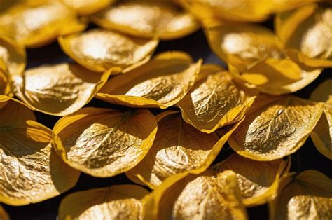 Gold Leaf Chips Are Laid Out On A Table Premium Ai Generated Image
