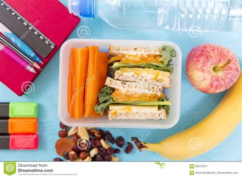 School Lunch Sandwich And Drink On Classroom Desk With Blackboard