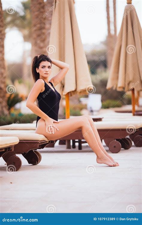 Brunette Woman Relaxing On Lounge In Luxury Hotel On Summer Holidays