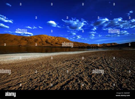 Sand Dunes And A Salt Lake At The Badain Jaran Desert In Inner Mongolia