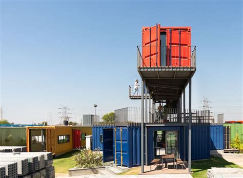 A Colorful Shipping Container Workspace On A Concrete Manufacturing Site