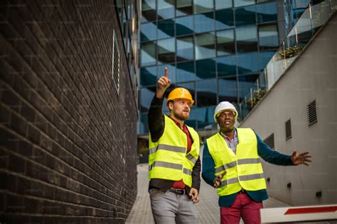건설 현장에서 건축가 동료와 건물의 구조에 대해 논의하는 엔지니어 사진 Unsplash의 흑인 남성 이미지