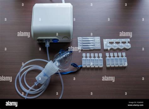 A Medical Nebulizer Machine With Attached Mask And Various Ampoules For