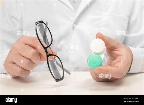 Contact Lenses Or Glasses Doctor Ophthalmologist Holding Eyeglasses