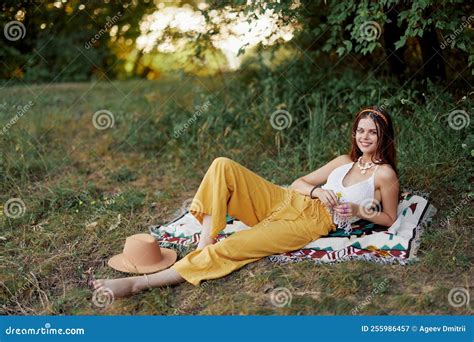 Young Beautiful Hippie Woman Lying On The Ground In Nature In The Fall