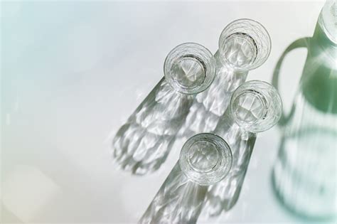 흰색 섬세한 녹색 노란색 최소한의 미적 평면도 자연광에서 반짝이는 유리 여름 음료 개념 파스텔 그라데이션 상호 작용 빛과 그림자에 그림자가 있는 물 유리 굴절에 대한 스톡