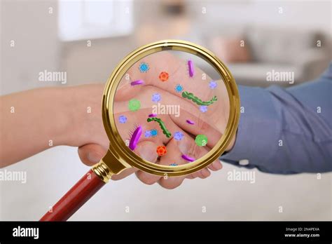 Magnifying Glass Detecting Microbes And Business Partners Shaking Hands