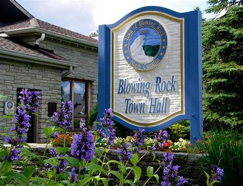 The Sign For Blowing Rock Town Hall Is Surrounded By Purple Flowers And