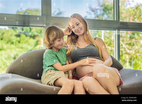 A Heartwarming Moment Pregnant Mother And Her Older Son Sit On The