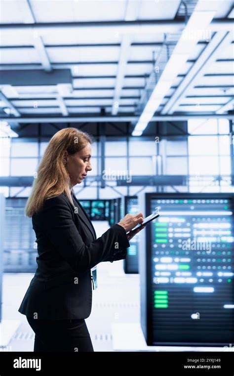 Software Developer Using Tablet In Data Center With Advanced Tech