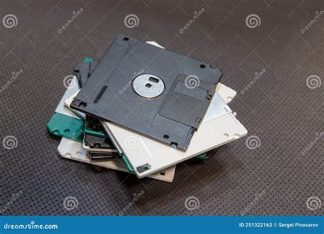 stack of old floppy disks stacked on a table obsolete disk media stock