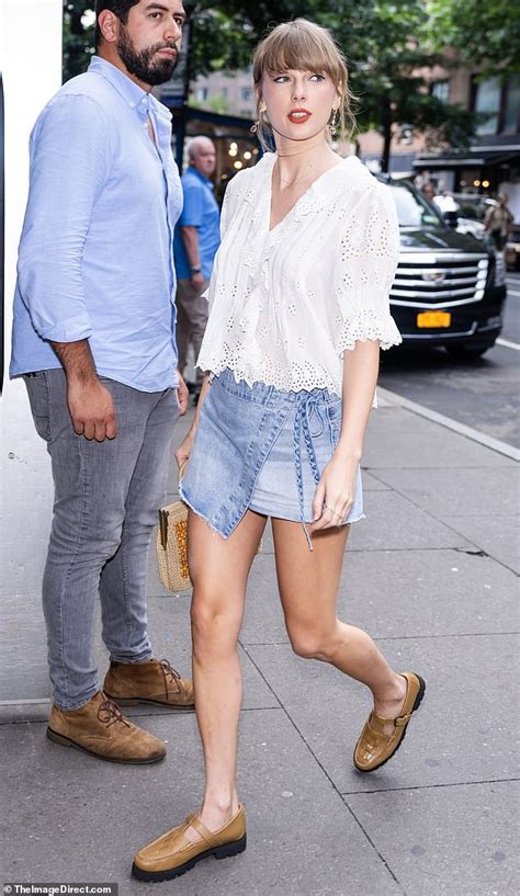 Taylor Swift Bares Her Long Legs In A Denim Skirt And White Blouse