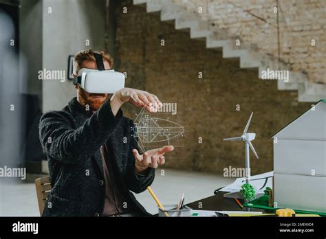 Architect Wearing Vr Simulator Gesturing With Wind Turbine Design At