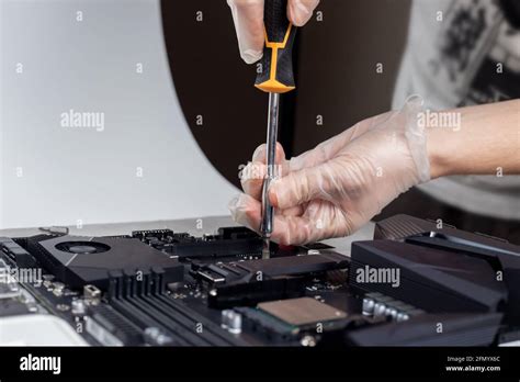 Technician Is Installing New Fast High Capacity SSD Drive On The Computer Motherboard Stock