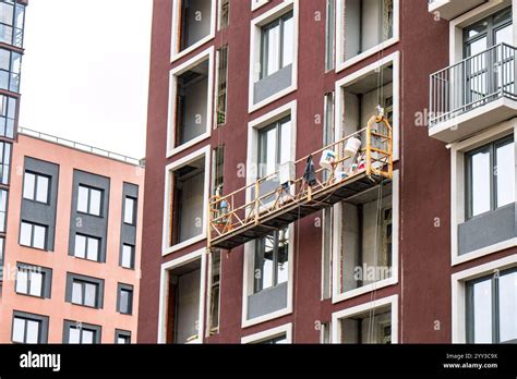 Construction Scaffold Suspended In Front Of A Modern Building Facade