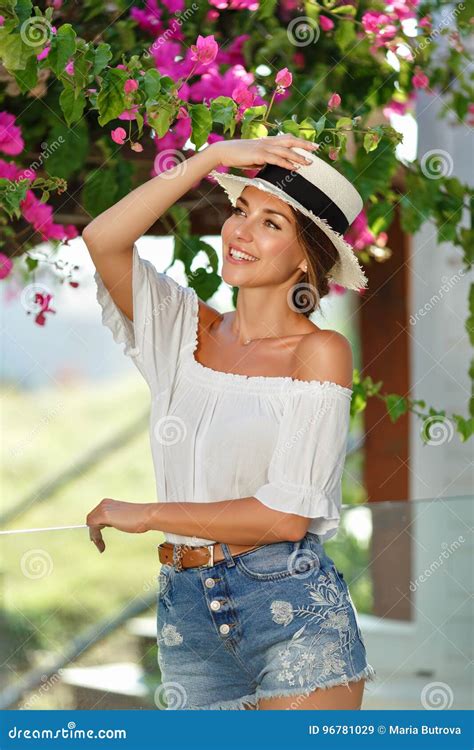 Tanned Beautiful And Girl In A White Hat Smiles In Summer Stock Image