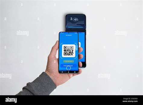 Smartphone Scanning A QR Code On A POS Terminal To Complete A Payment Highlighting An