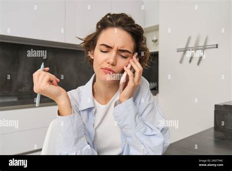 Image Of Woman With Confused Face Answering Phone Call And Looking Puzzled Cant Understand
