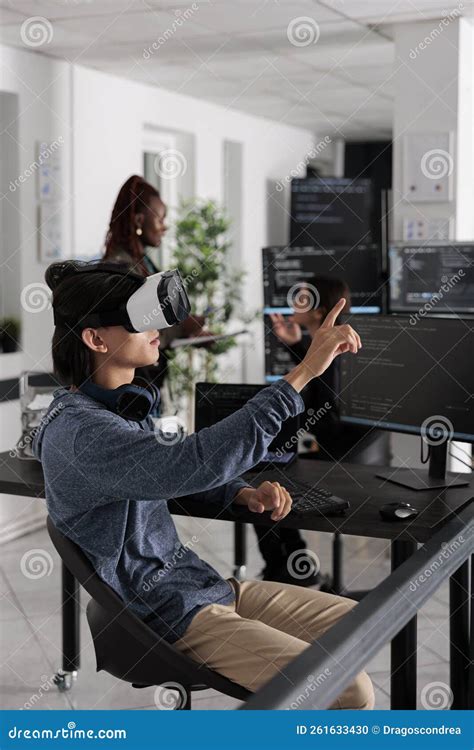 Software Developer Wearing Virtual Reality Headset Working To Develop Security Program Stock