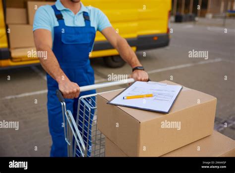 Closeup Trolley Cart With Cardboard Box Stack And Clipboard Checklist