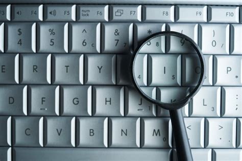 Premium Photo Magnifying Glass On Computer Keyboard