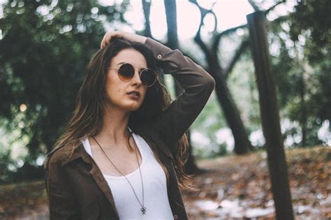 Premium Photo Portrait Of Beautiful Woman Wearing Sunglasses Against