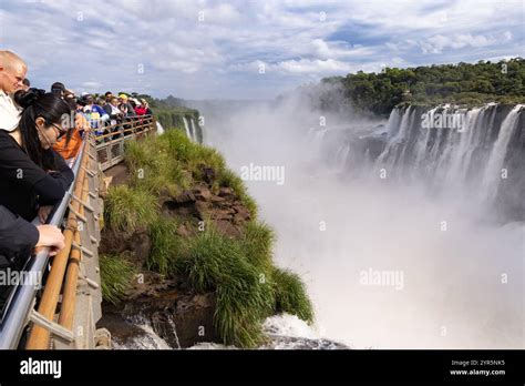 Iguazu Falls Tourism Tourists Looking At The Waterfall From A Walkway
