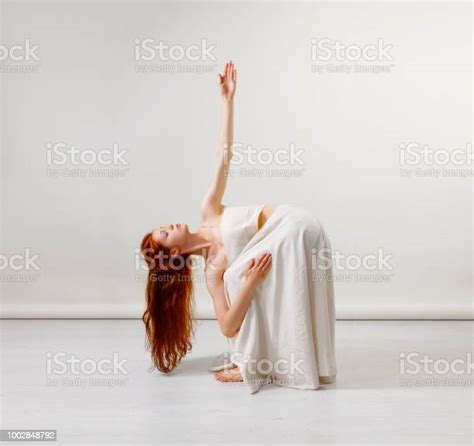 Young Redhead Woman Does Stretching And Yoga Poses Dancing Contemporary