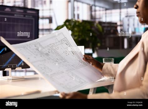 Architect Drawing Construction Blueprint After Researching And Analyzing Building Codes And