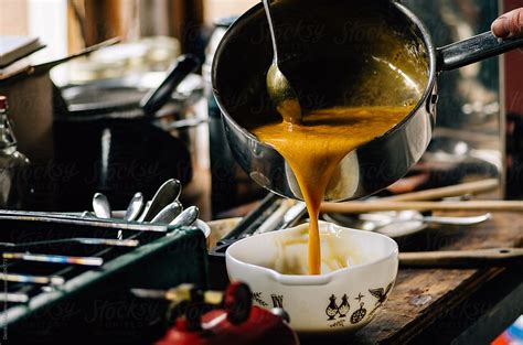 Pouring Boiling Syrup Into Bowl To Make Maple Candy By Stocksy Contributor Deirdre Malfatto