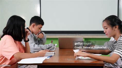 Group Of Middle School Students Working In Classroom High Res Stock