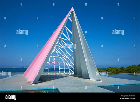 A Modern Pink Sculpture Loosely Modeled As A Church At The Beach On