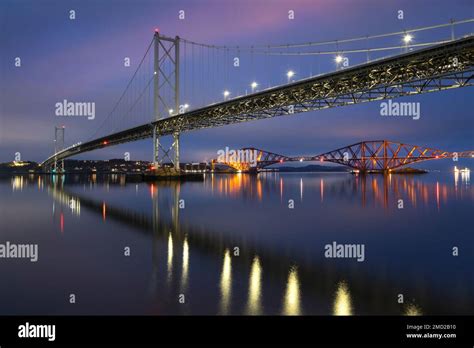 The Forth Road Bridge And Forth Railway Bridge At Night Spanning The Firth Of Forth Queensferry