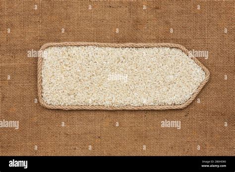 Symbolic Pointer Made Of Rope With Rice Grains Lying On A Burlap Top
