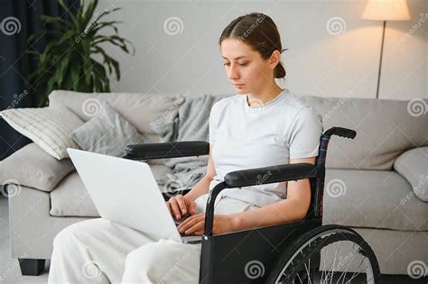 Female Freelance Programmer Sitting In Wheelchair And Using Computers While Coding Web Game At