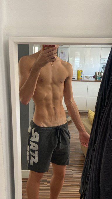 A Shirtless Man Taking A Selfie In The Mirror