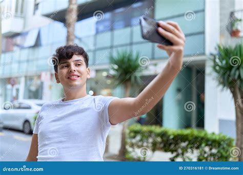 Non Binary Man Smiling Confident Making Selfie By The Smartphone At