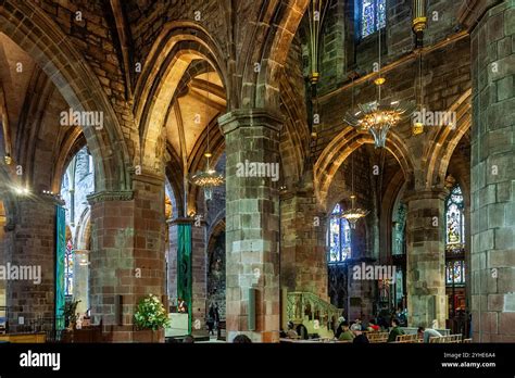 The Gothic Interior With Stained Glass Windows And Round Arches Of St