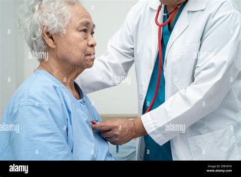Doctor With Stethoscope Checking Senior Or Elderly Old Lady Woman