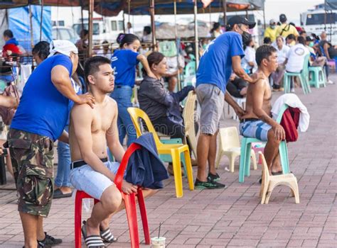Local Filipino Man Receives Open Air Massage Treatmentalong The