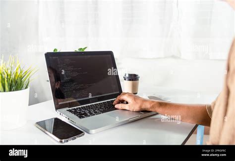 programmer woman writing program html code sitting at workplace in