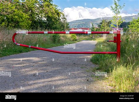 The Road Is Closed With A Barrier White And Red Railing Metal