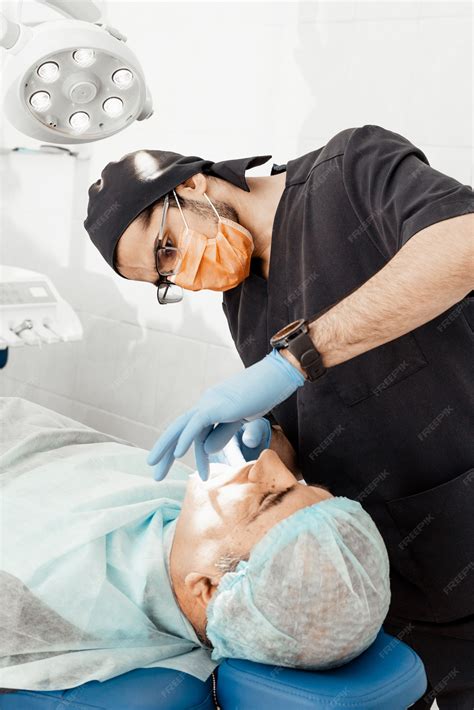 Premium Photo Patient And Dentist During Implant Placement Operation