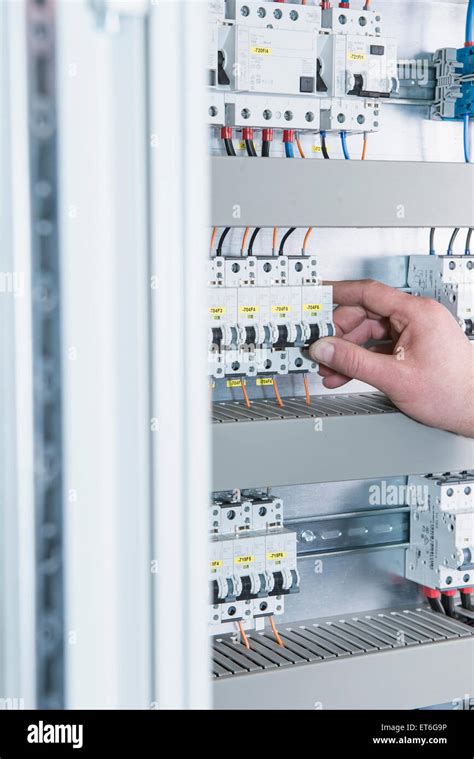 Close Up Of Electrician Switching Electrical Fuse In Distribution Fusebox Munich Bavaria