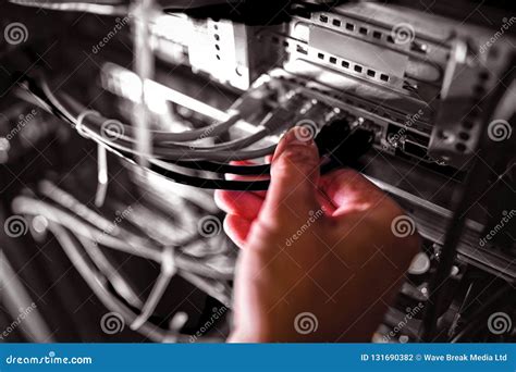 Close Up Of Technician Plugging Patch Cable In A Rack Mounted Server Stock Photo Image Of