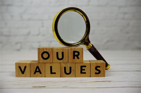 Our Values With Wooden Blocks Alphabet Letters And Magnifying Glass On Wooden Background Stock